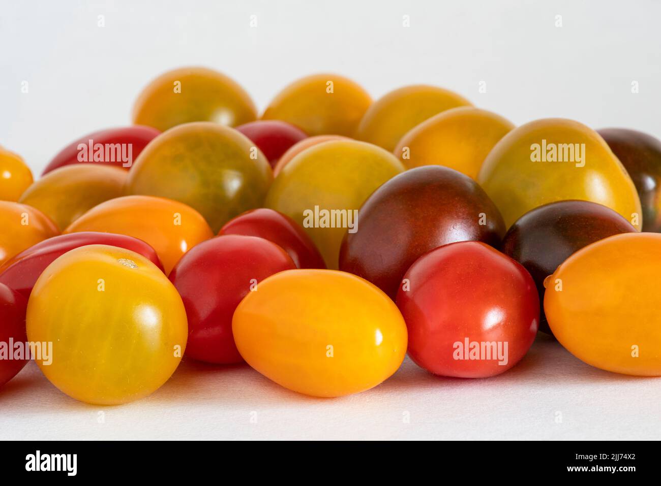 Close-up of a group of cherry tomatoes of different colours, yellow ...