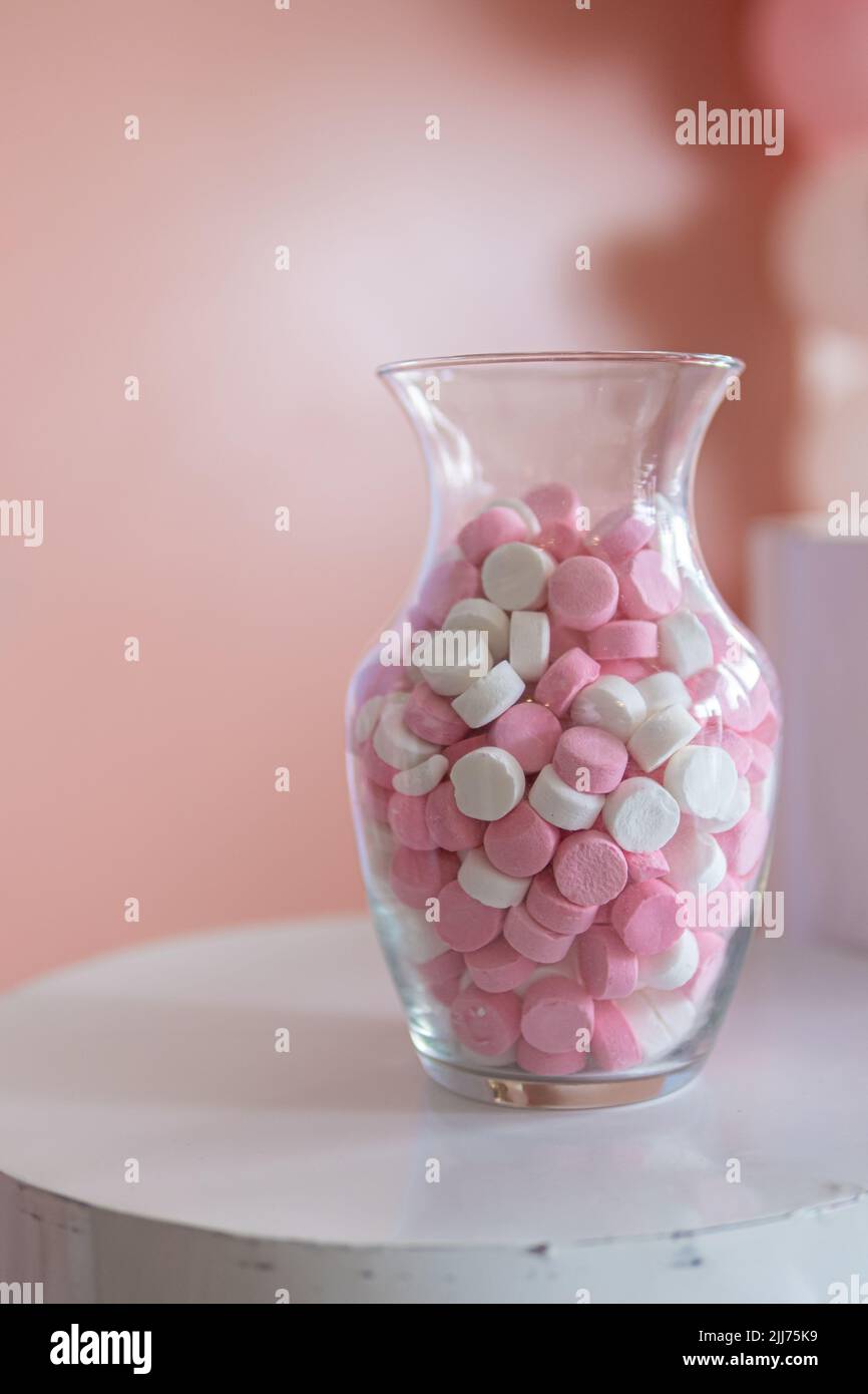 Pink and white sweets in a jar Stock Photo - Alamy