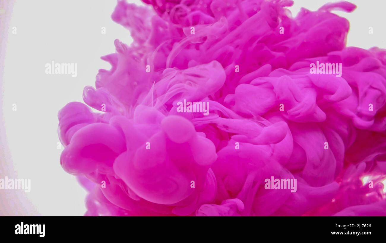 a pink color ink flowing in water isolated on white background Stock ...