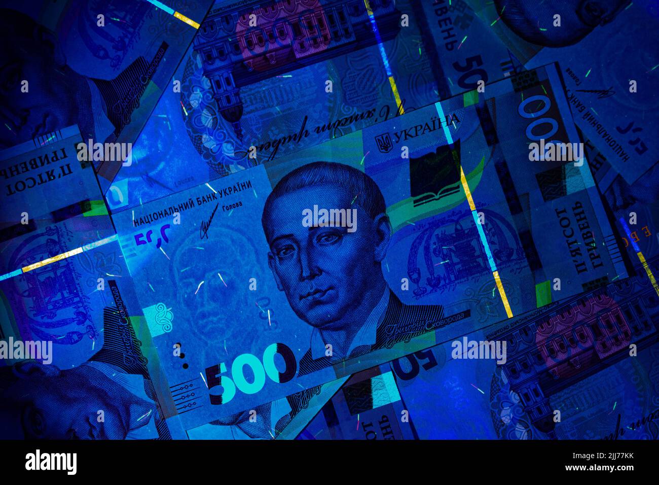 Ukrainian currency hryvnia in ultraviolet rays. The beam of the UV ...