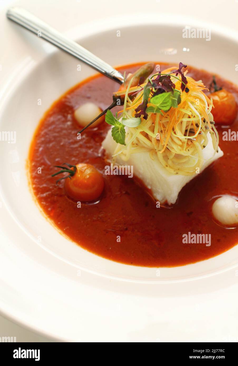 A steamed cod fish in hot and sour gravy on a white bowl Stock Photo ...