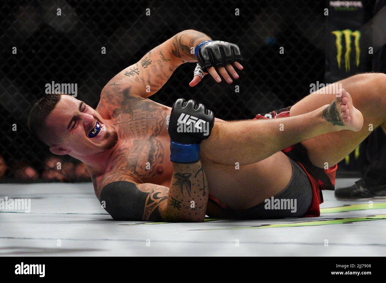 LONDON, UK - JULY 23: Tom Aspinall in pain after a serious Knee injury ...