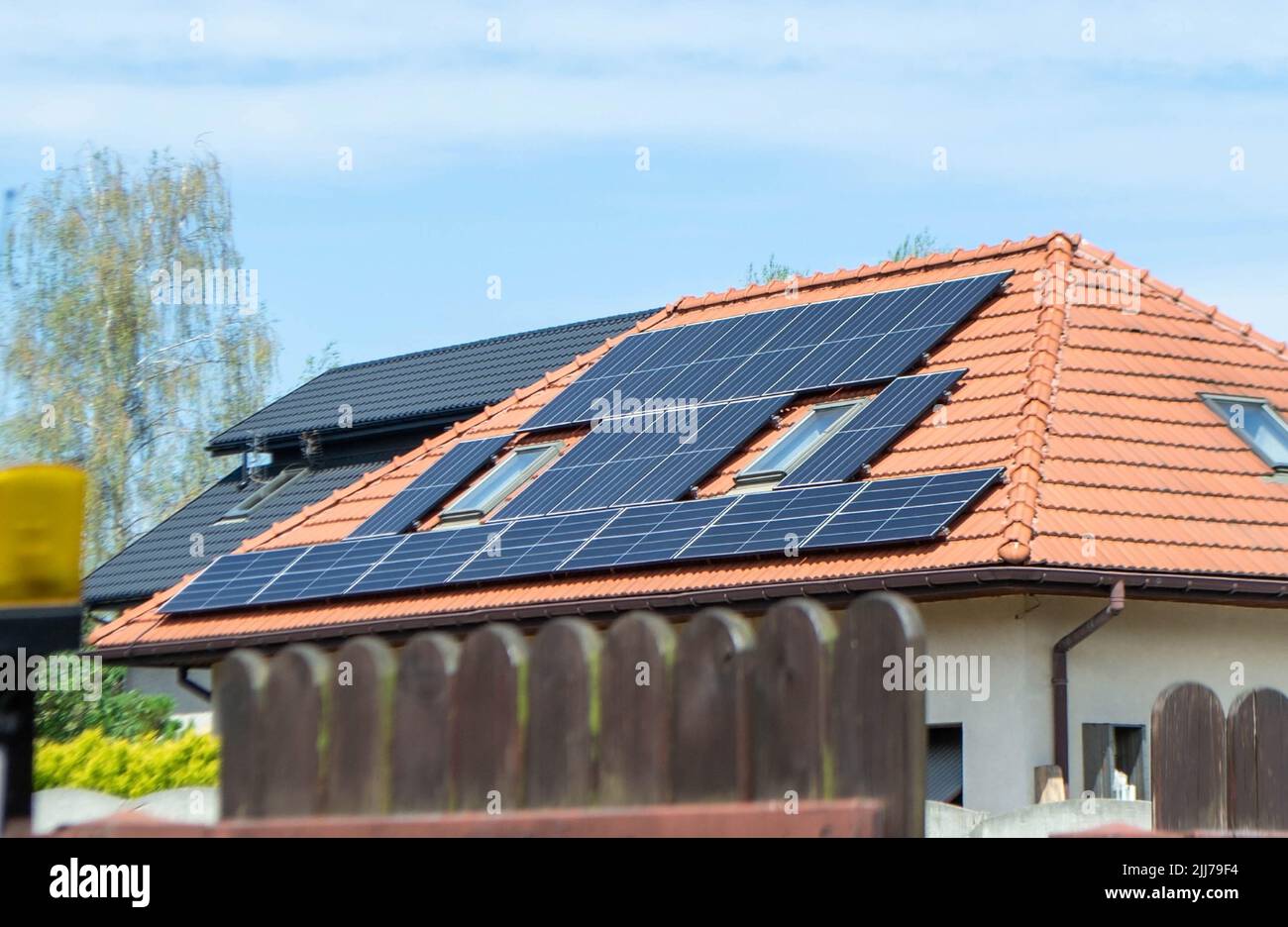 House roof with photovoltaic modules. Historic farm house with modern ...