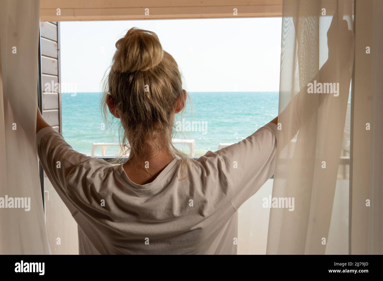 Sea home open curtains woman window morning back view house, for ...