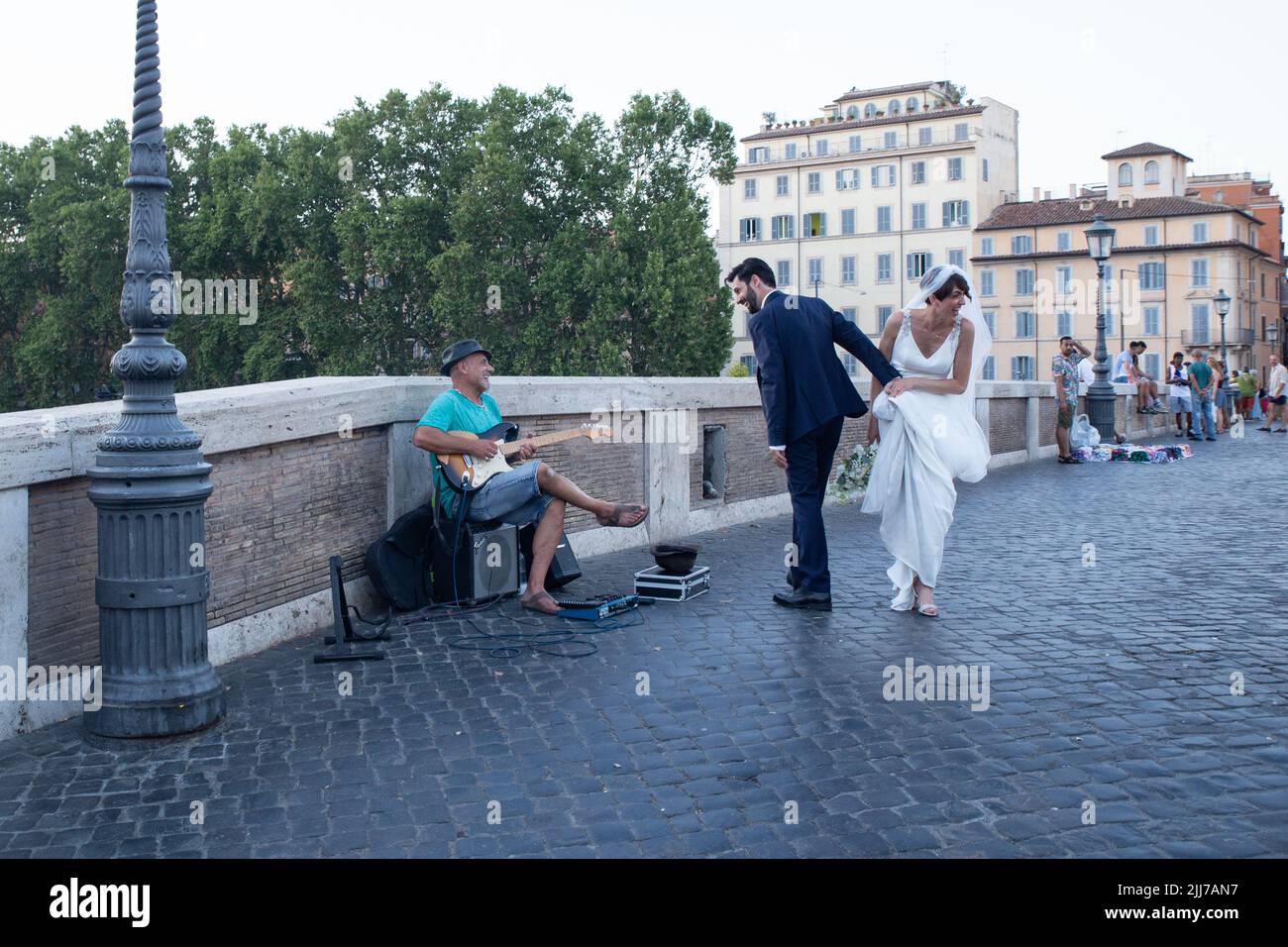 Rome, Italy. 23rd July, 2022. A married couple walks on Sisto Bridge in ...