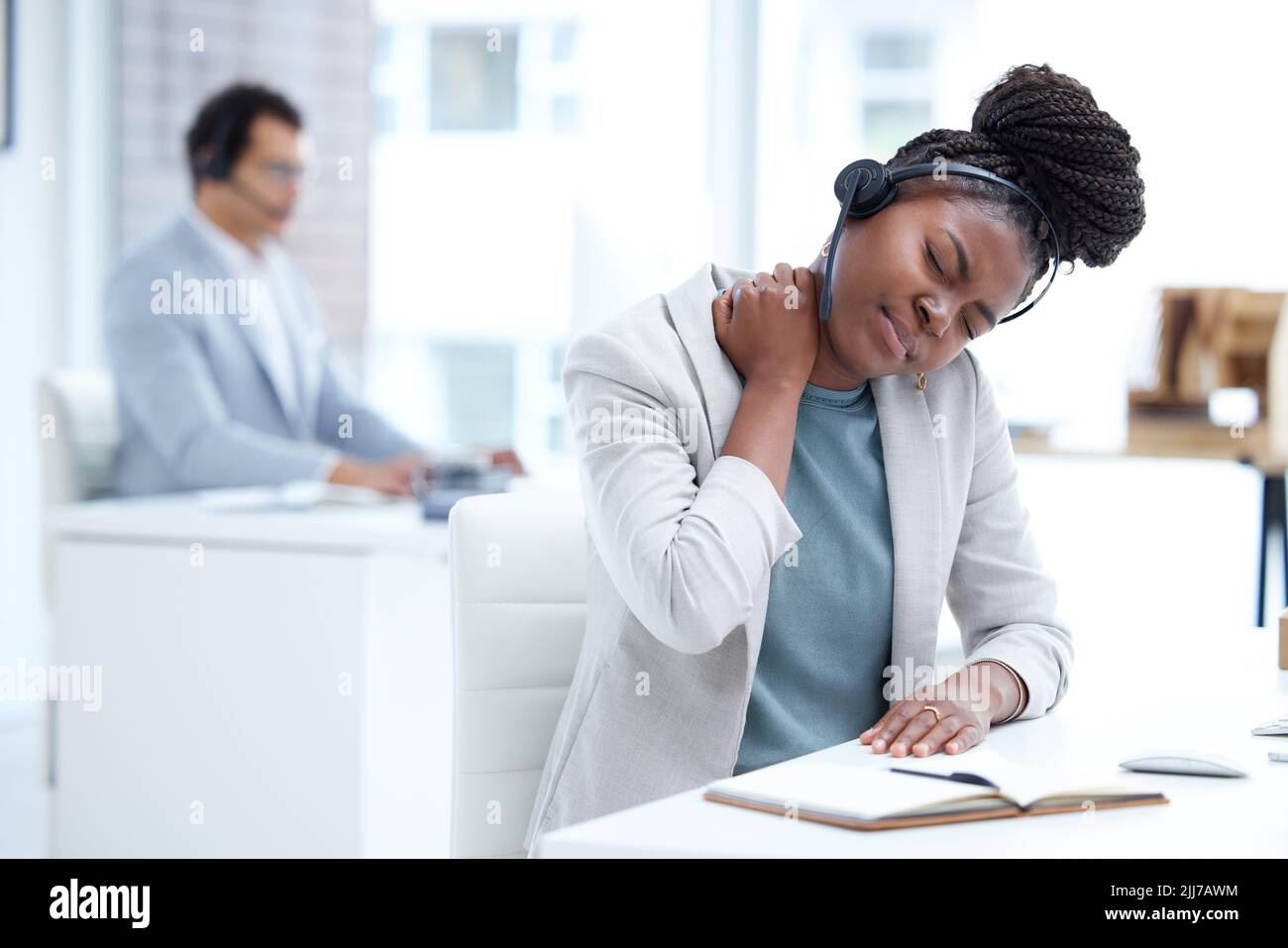 Being at a desk all day can be very straining. a young call centre ...