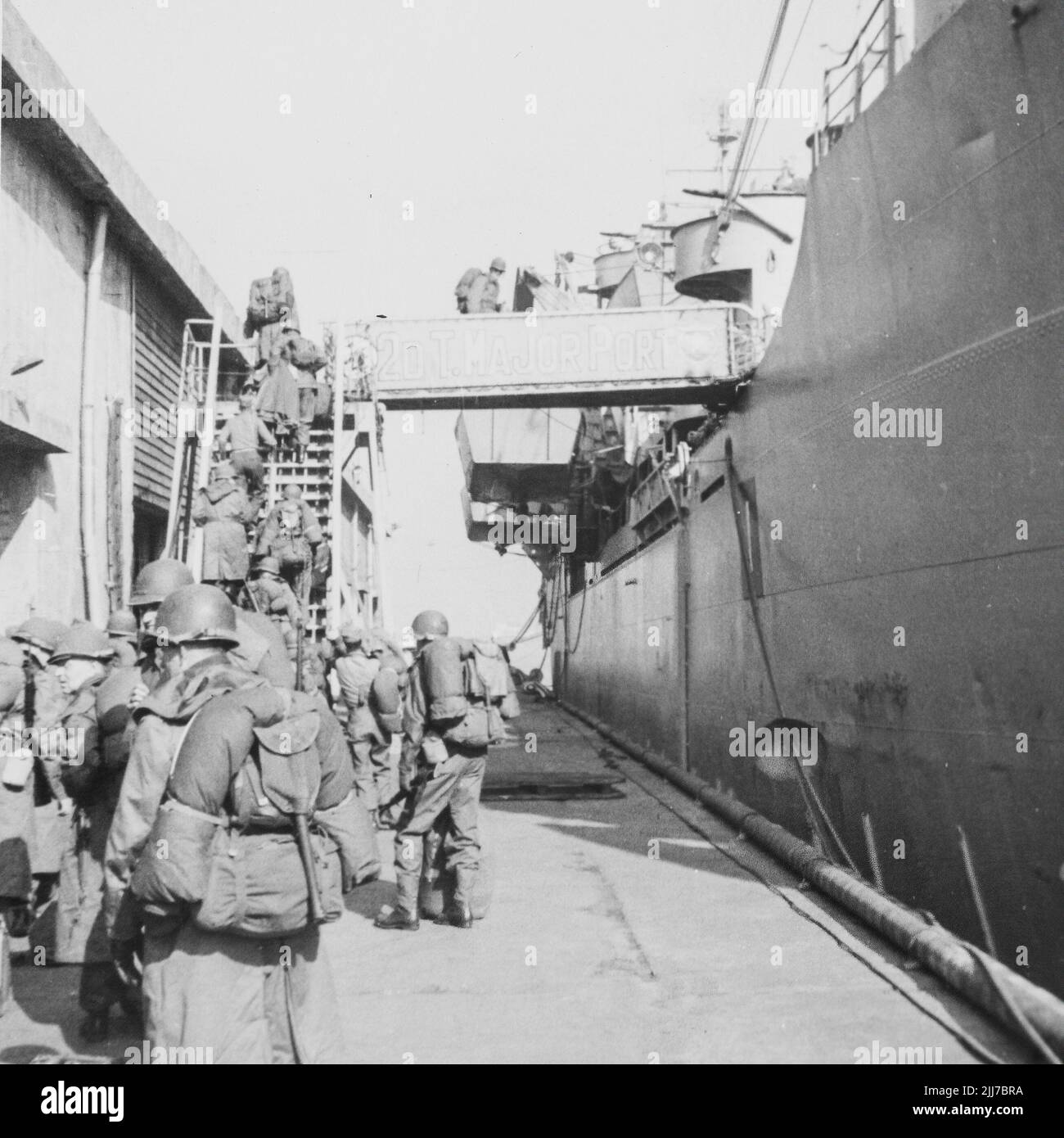 United States Army Troups during the Korean War. Men load USS Bexar at ...