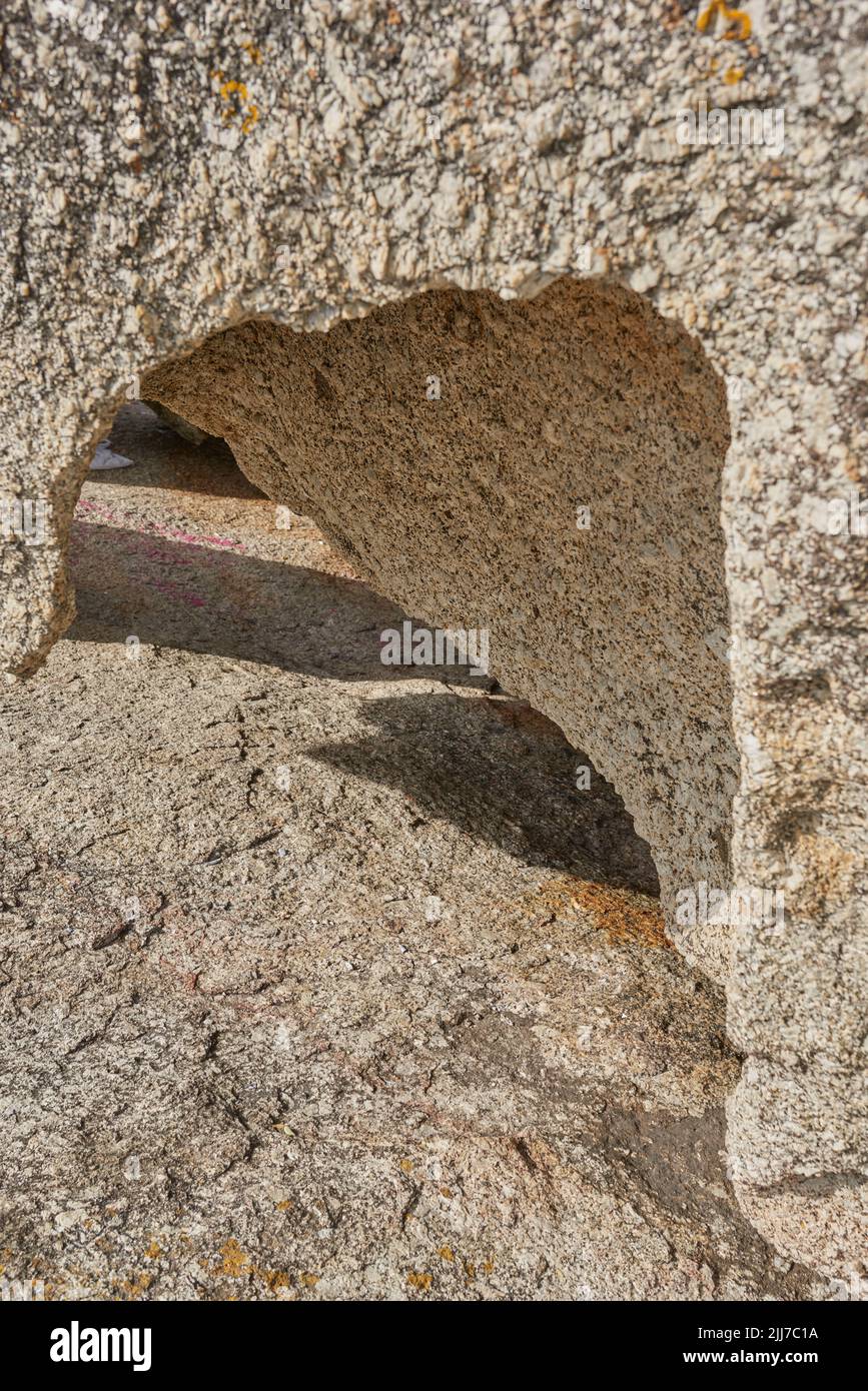 Closeup of rough rock with deep cracks, holes and crevices from wind ...