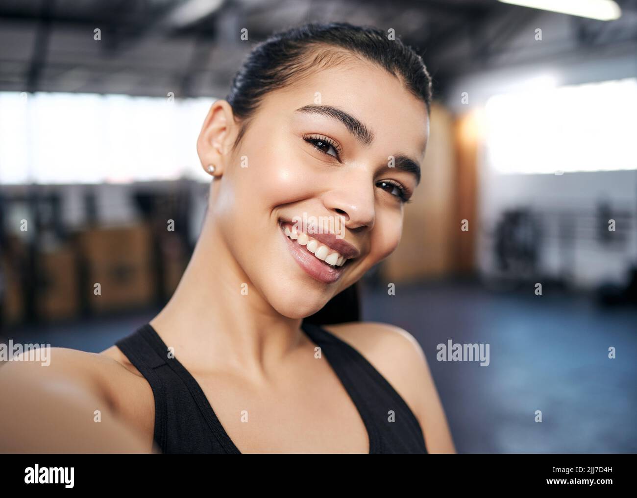 Everything you do is everything youll become. Portrait of a fit young woman taking selfies at ...