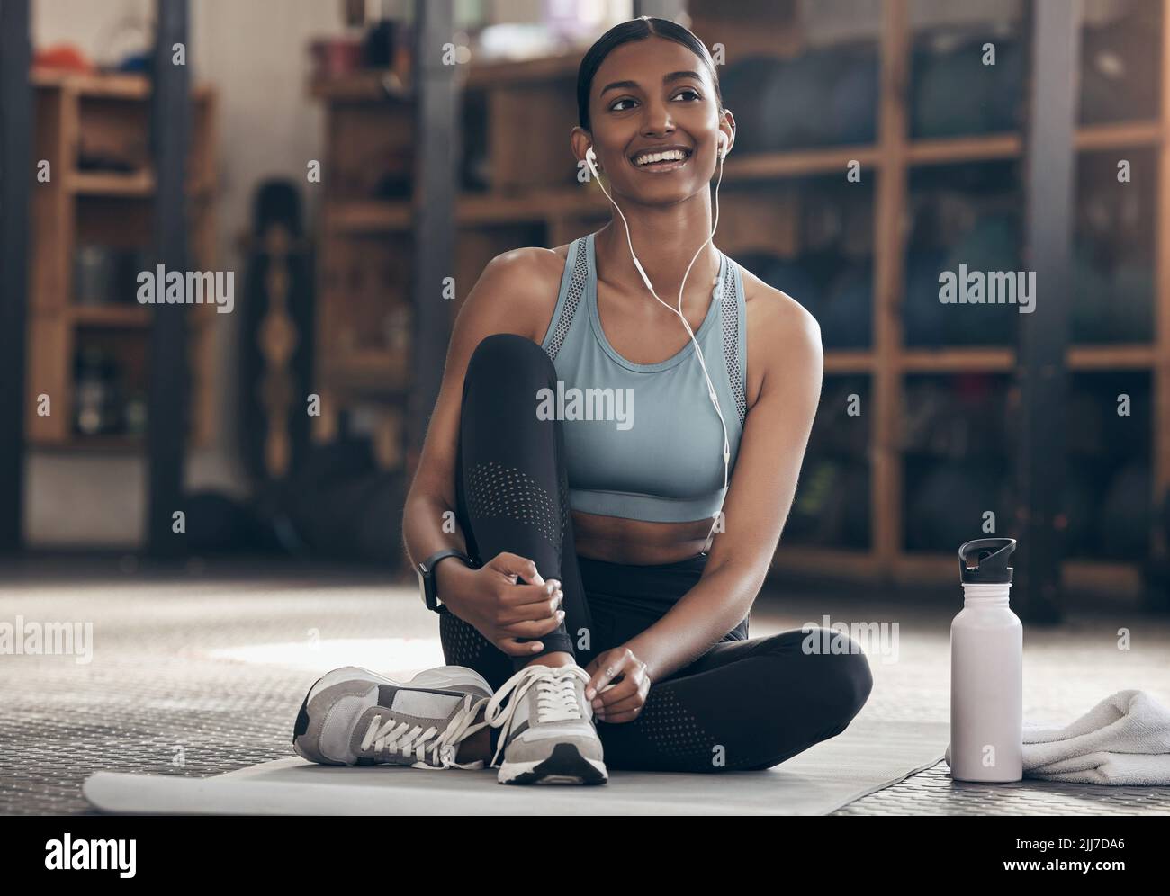 I cant go without my workout playlist. a sporty young woman listening ...