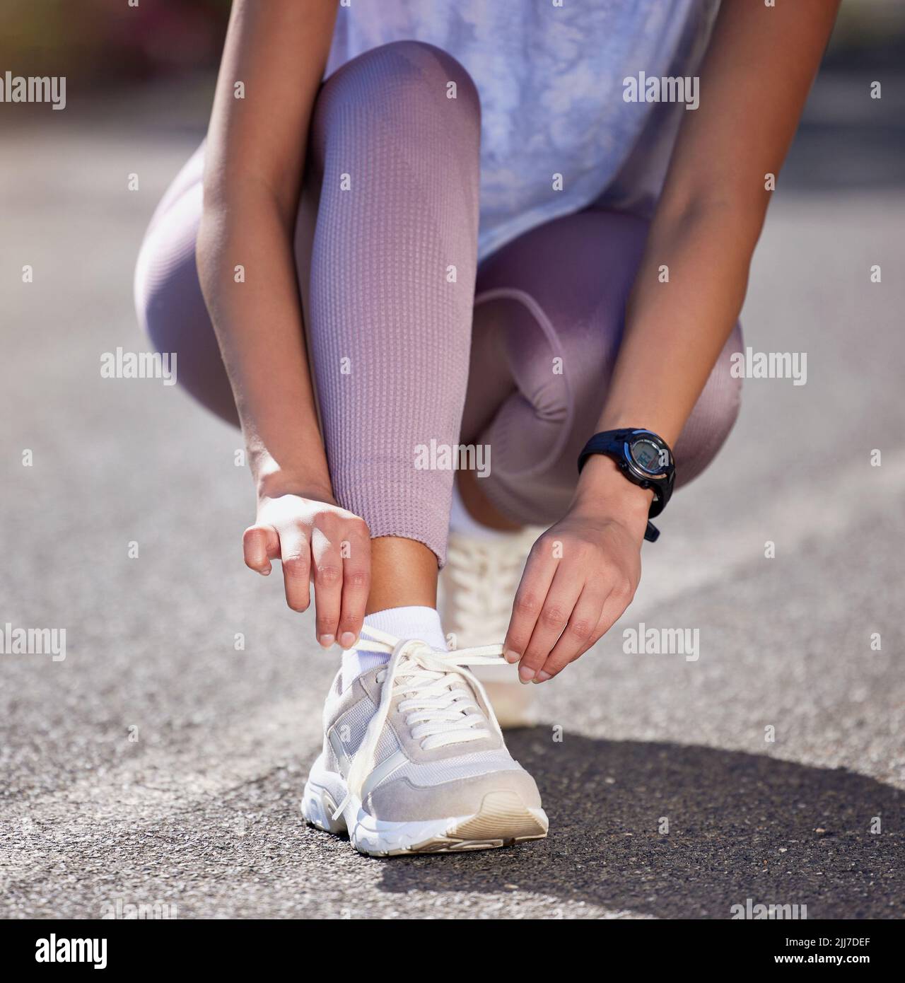Fasten your laces. an unrecognizable female athlete tying her laces ...