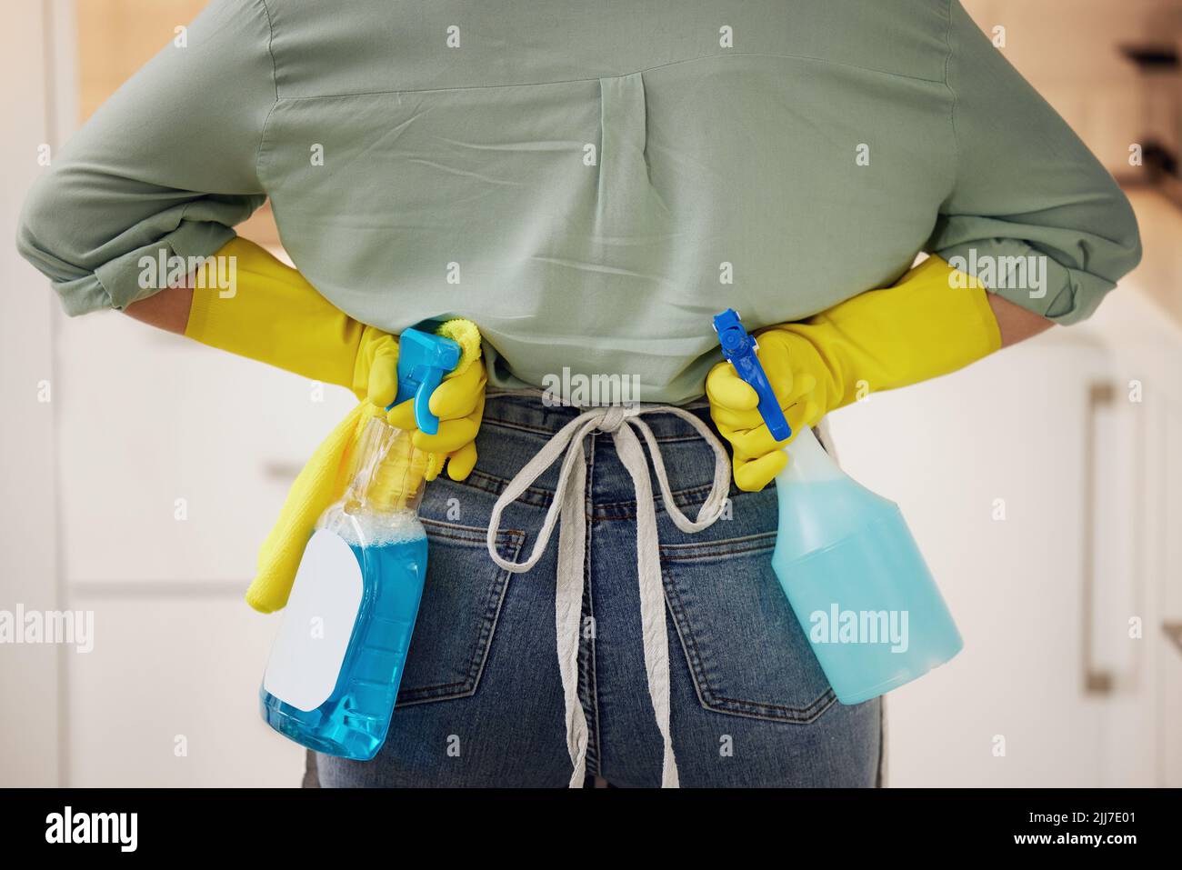 Urgh, look at this mess. a woman standing ready with cleaning supplies ...