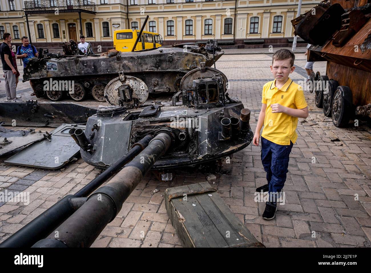 A boy walks past the wreckage of a turret from a Russian T-72 in Kyiv ...