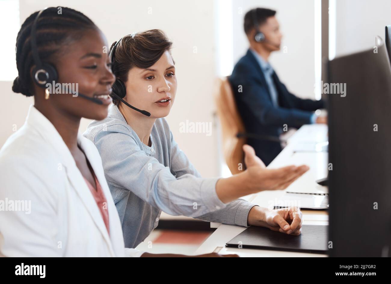 Ill show you a quicker way to do it. two call centre agents working ...