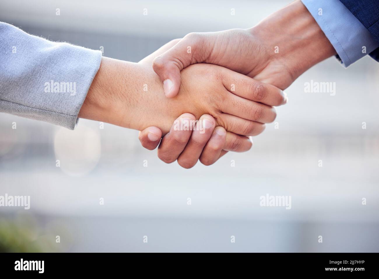 The gentlemens agreement. two unrecognizable businesspeople sharing a ...