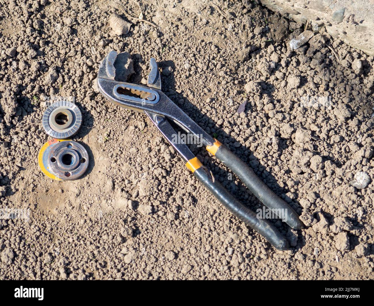 wrench or tongue-and-groove pliers and bearings on the ground Stock ...