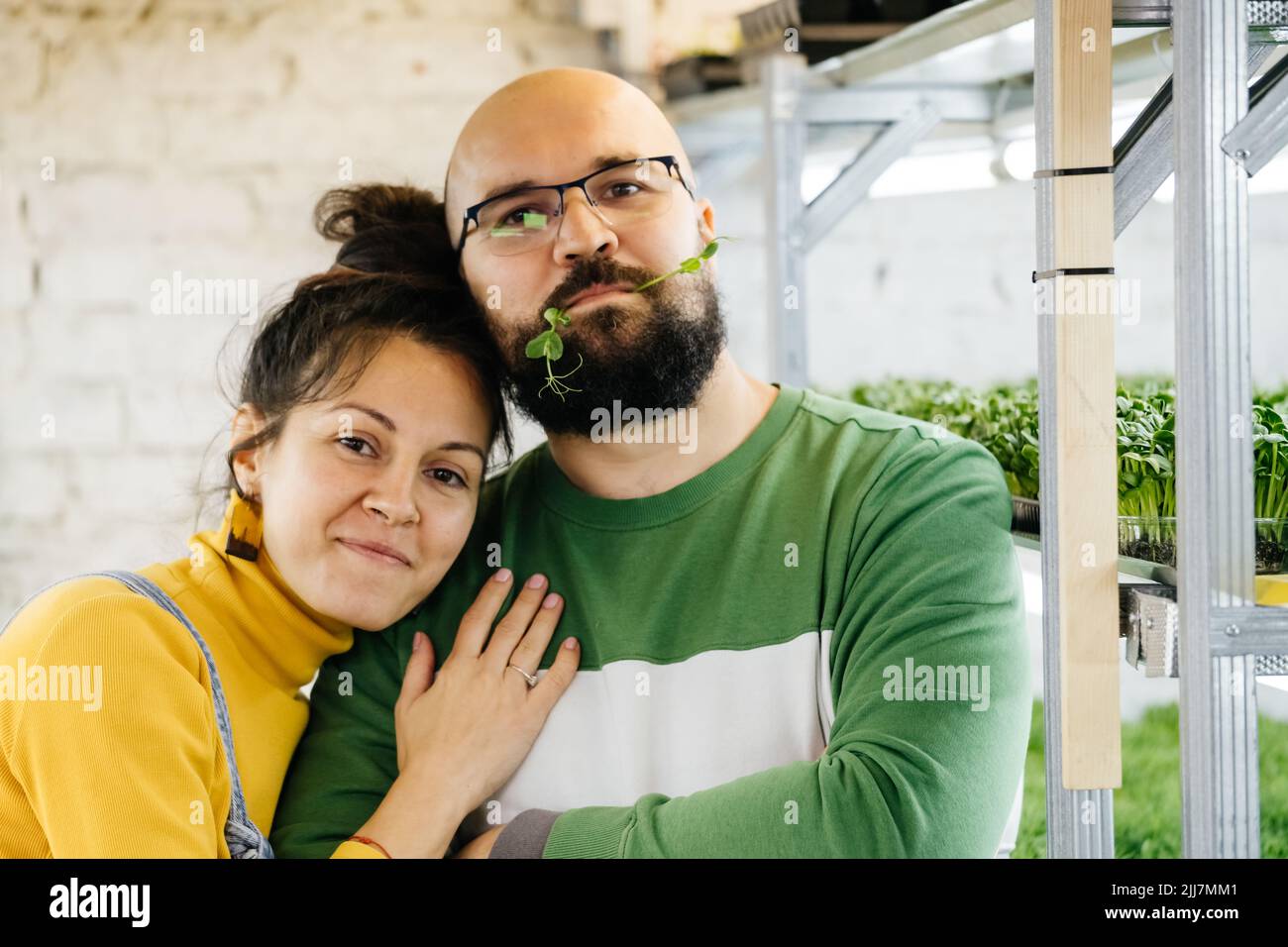 Couple having fun on the microgreen farm, happy working together ...