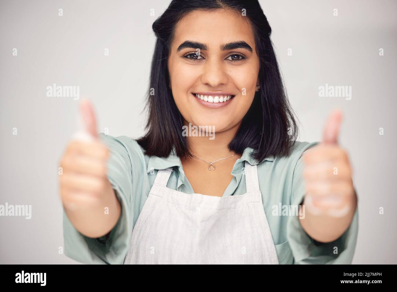 Sipping her way into a clean home. a woman showing thumbs up with her ...