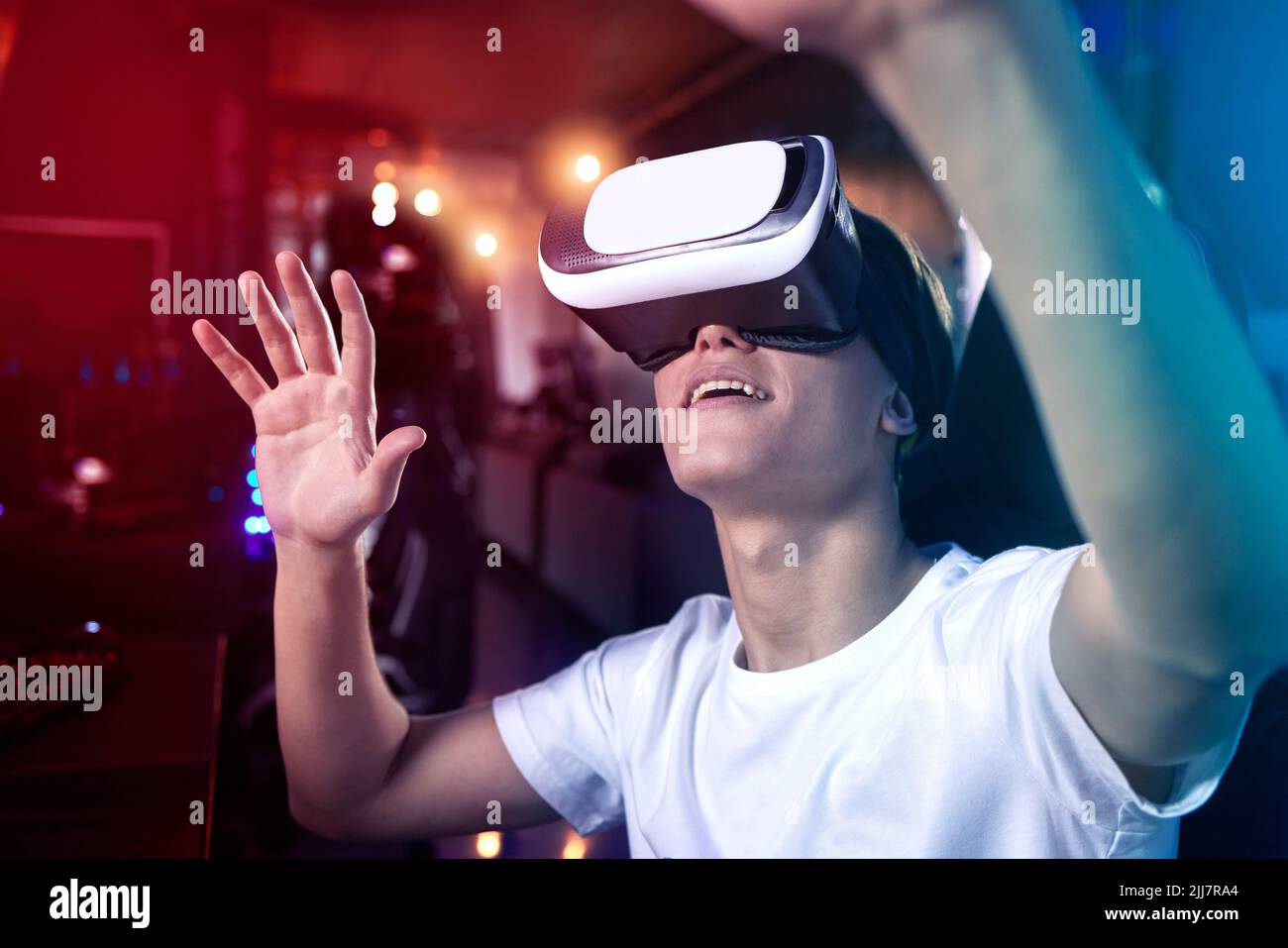 Whats real and whats not. a young man using 3d goggles while playing ...