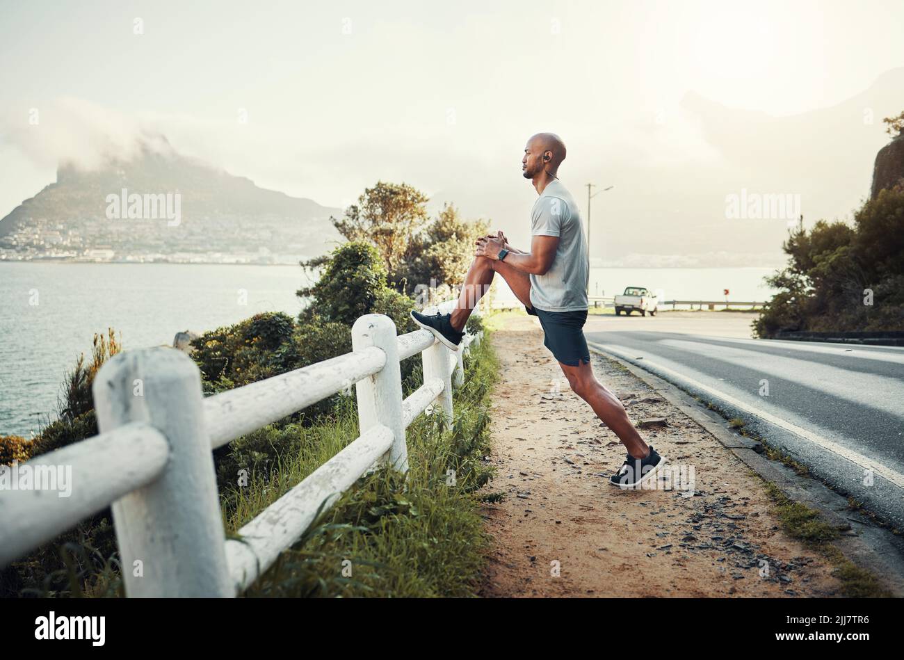 Exercise is normal for me. a sporty young man stretching while ...