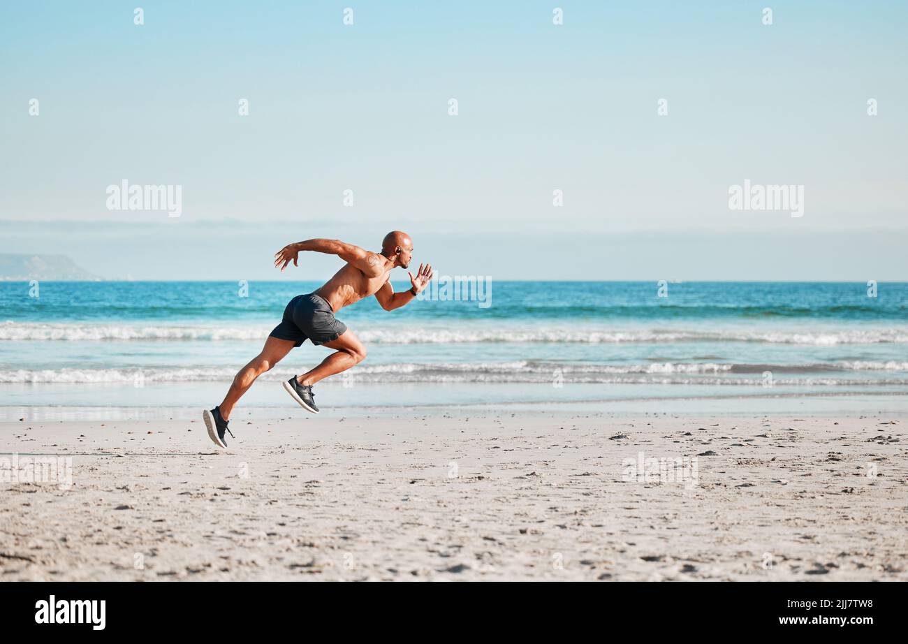 Perseverance is the hard work. a young man sprinting on the beach Stock ...