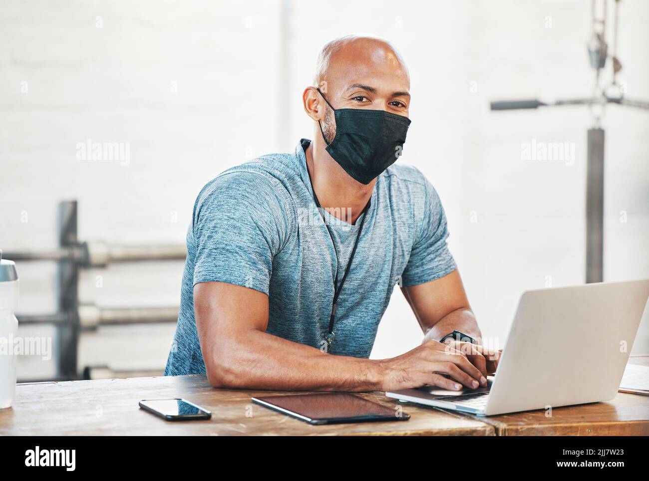 We stay safe while staying fit. Portrait of a muscular young man ...