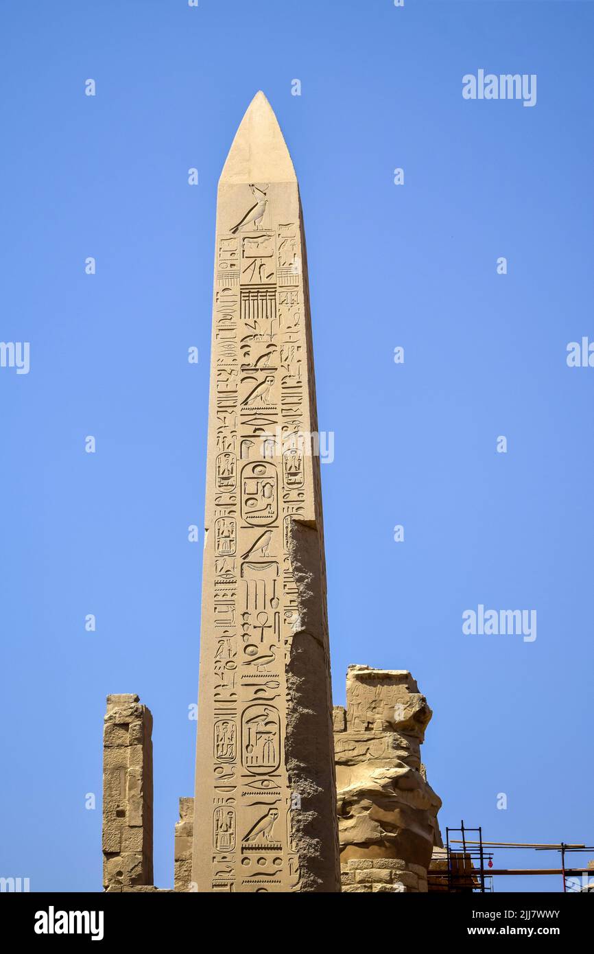 Tall pillar with carved ancient hieroglyphs in Karnak Temple complex ...