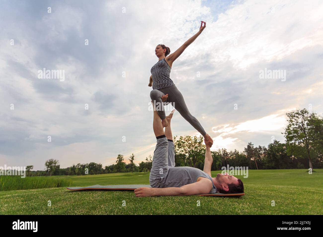 Strong acrobatic woman lifting man hi-res stock photography and images ...