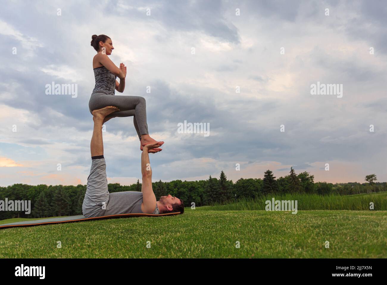 Strong acrobatic woman lifting man hi-res stock photography and images ...