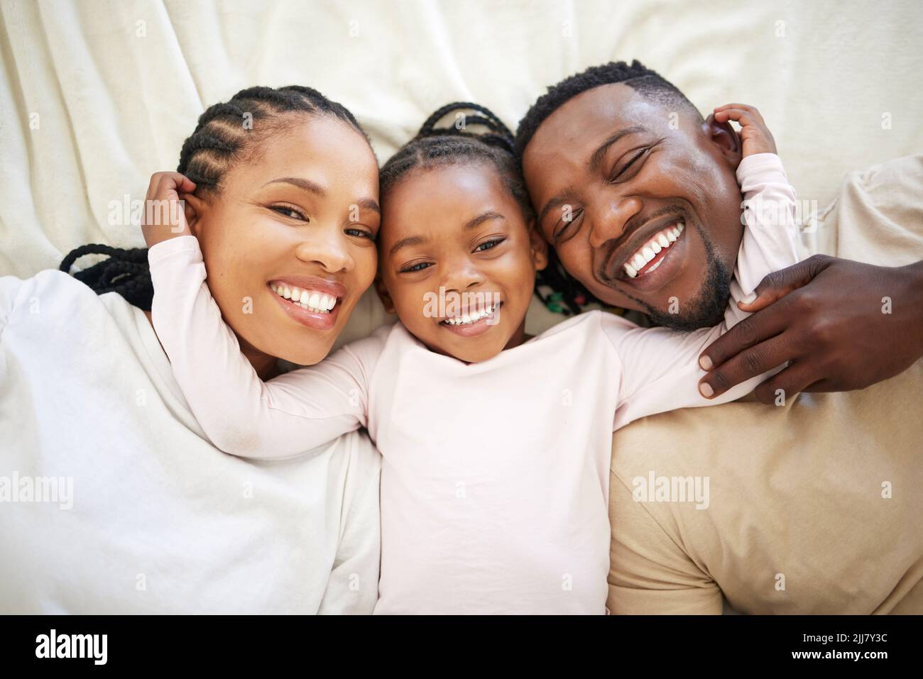 Theres nothing that makes you more insane than family. a beautiful young family bonding in bed ...