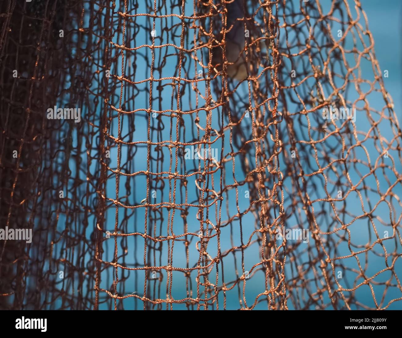 Brown fisher net to catch fish Stock Photo - Alamy