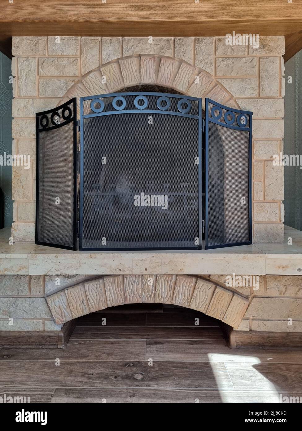 Fireplace with a portable iron lattice. Classic style fireplace made of ...