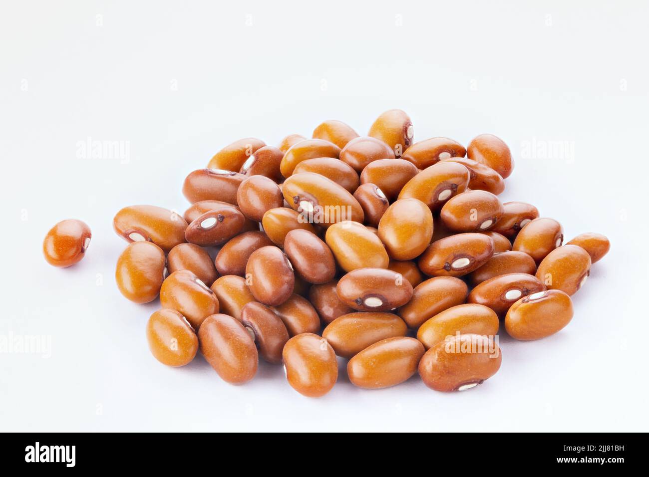 Dried orange beans on a white plate. Healthy food concept Stock Photo ...