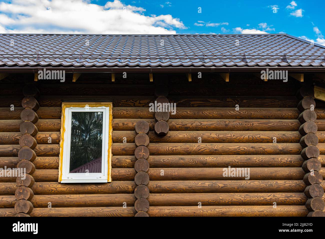 plastic window installed in a wooden log house. High quality photo ...