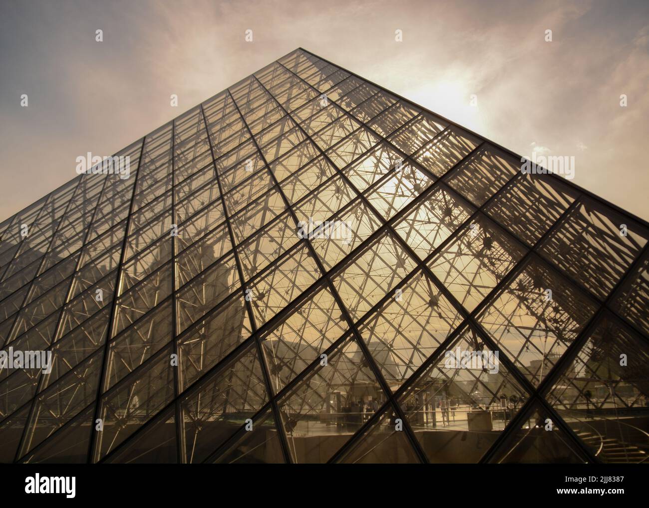 The glassy pyramid of the Louvre museum at the sunset Stock Photo - Alamy