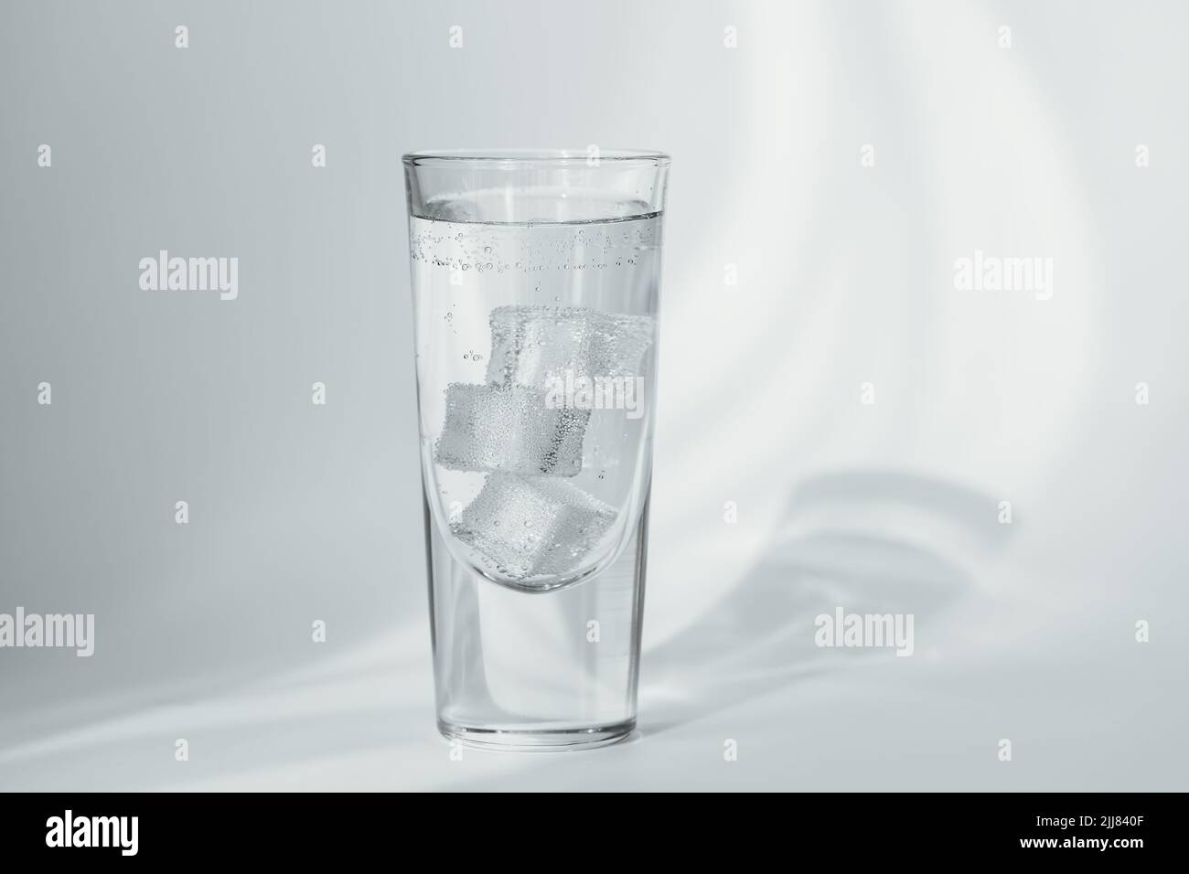 Glass of clean mineral sparkling water with ice on white background Stock Photo - Alamy