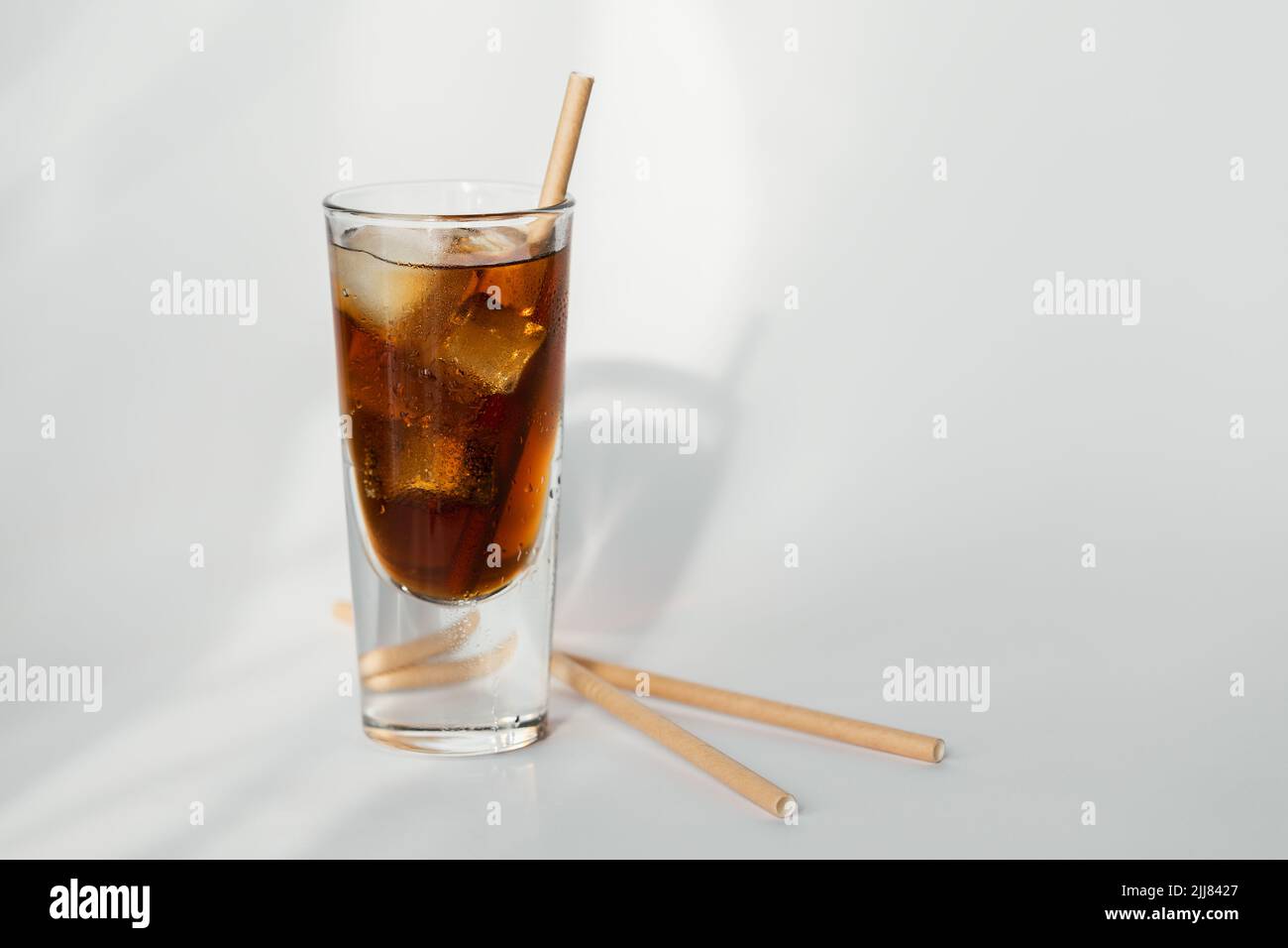 Glass of cola with ice and straw on a white background Stock Photo - Alamy