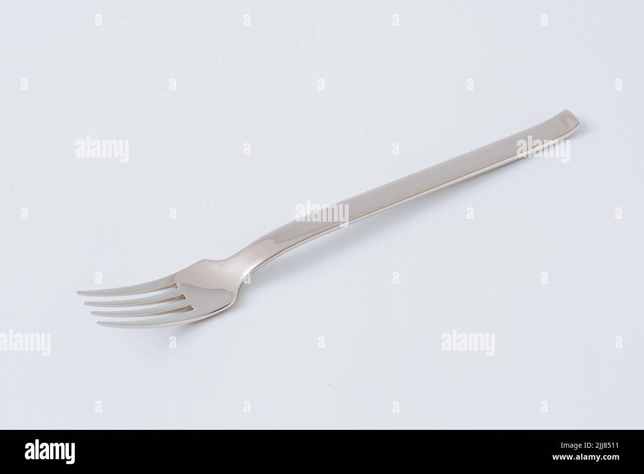 Stainless steel fork for eating on white background, kitchenware, copy ...