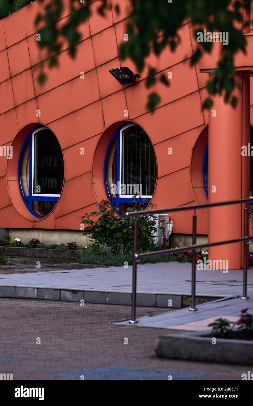 A sidewalk near an orange building Stock Photo - Alamy