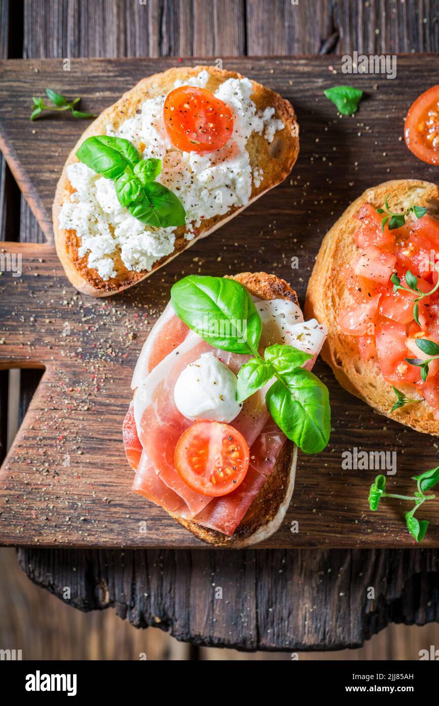 Homemade and aromatic mix of bruschetta as classic snack for breakfast ...