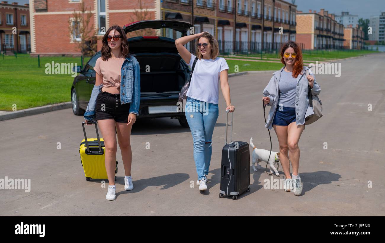 Three friends are going to travel by car. Summer vacation Stock Photo ...