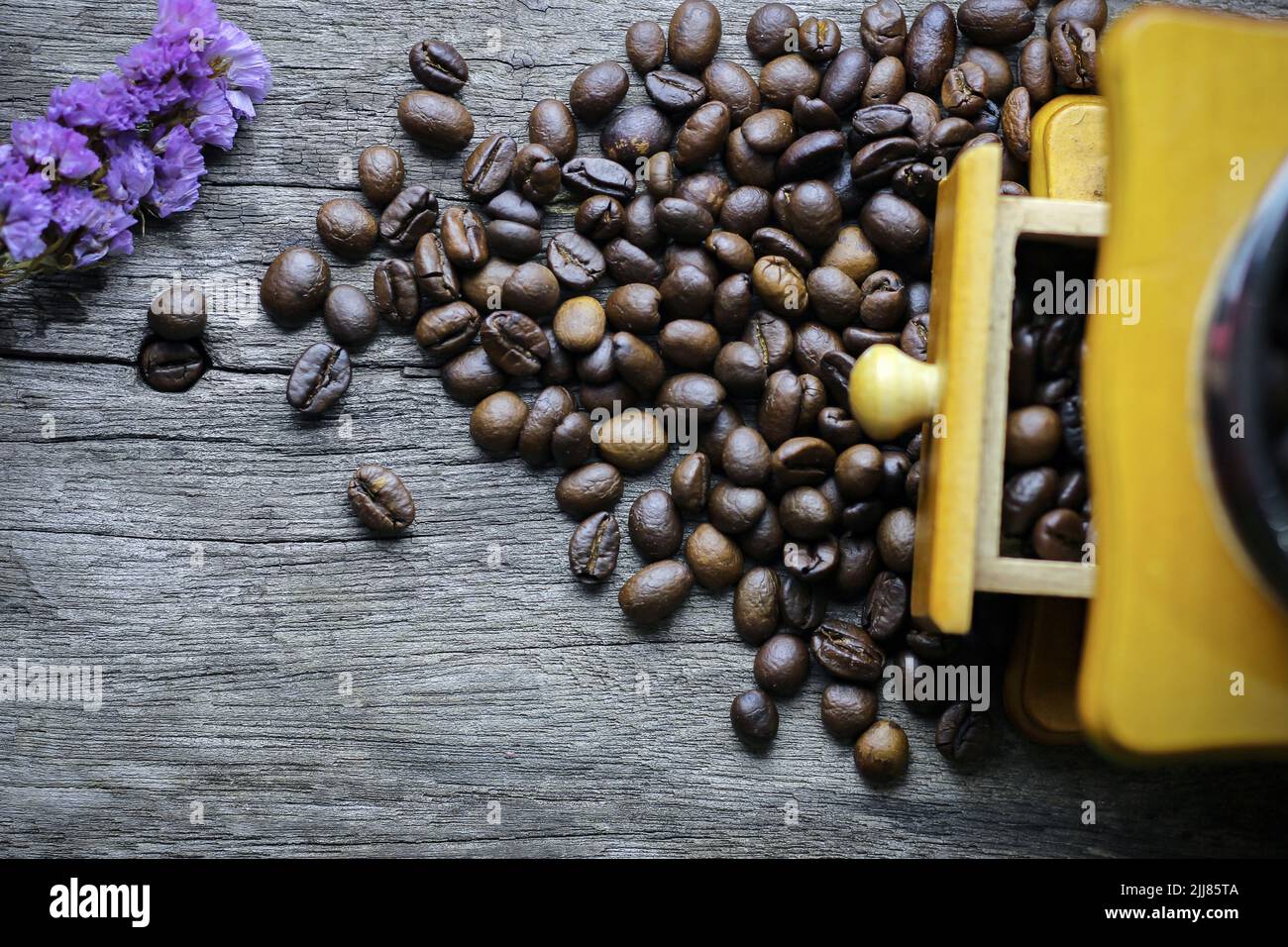 picture of coffee beans stacked on wooden floor on a dark background ...