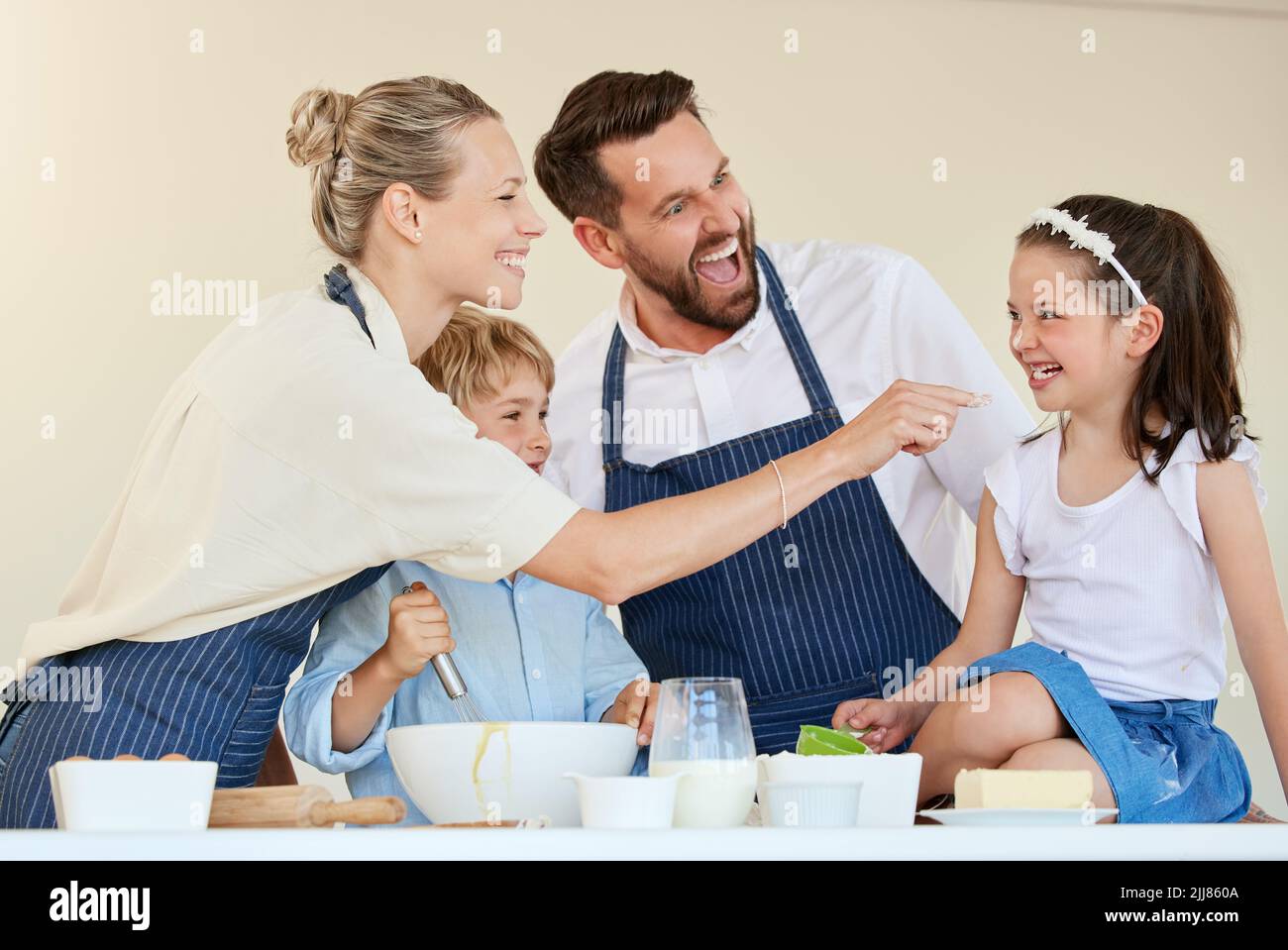 Things are getting messy. a young family cooking together at home Stock ...