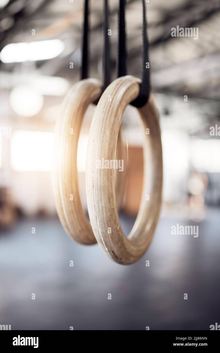 Work harder than yesterday. gymnastic rings in a gym with no people ...