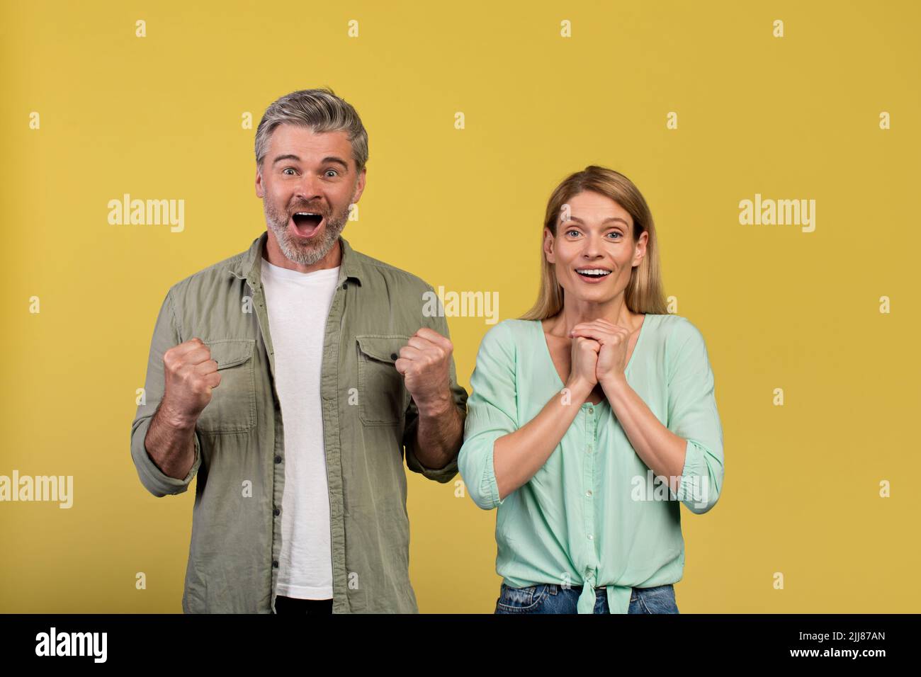 Wow, yes. Overjoyed middle aged man and woman cheering and shaking ...