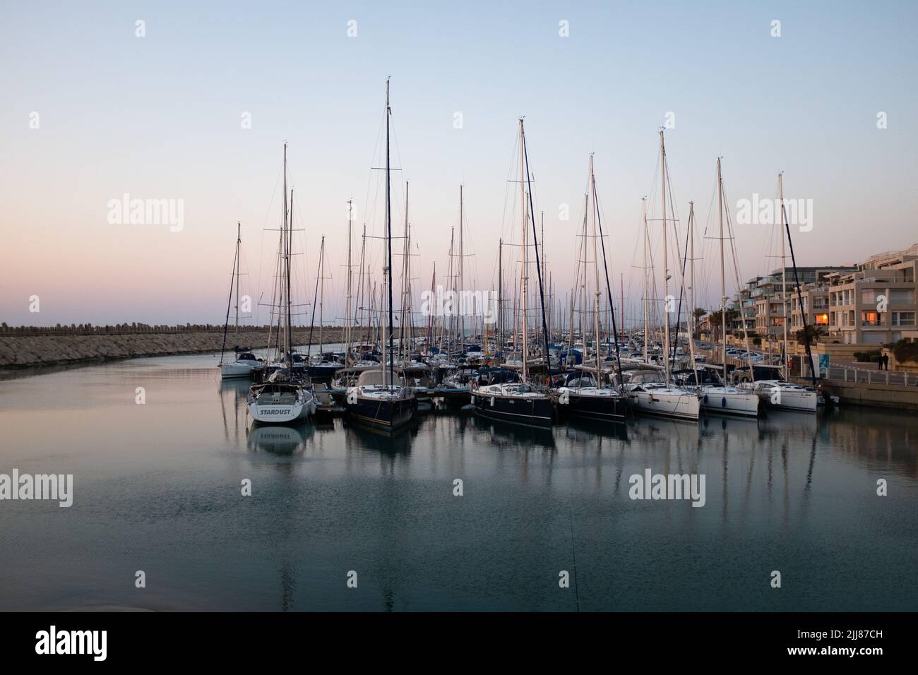 Yachts and sailing boats are seen at a seaside port Stock Photo - Alamy
