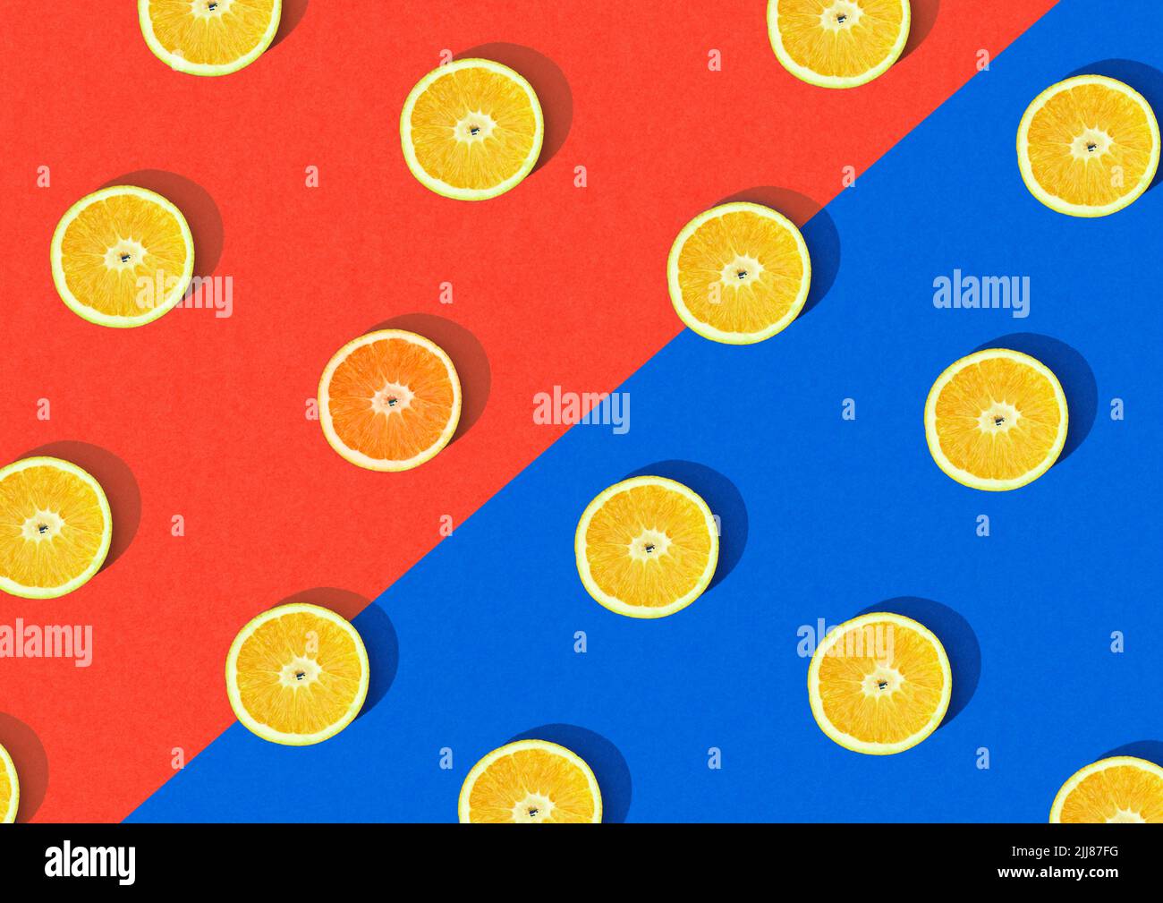 Orange and lemon slices Fruit pattern isolated on red and blue split ...