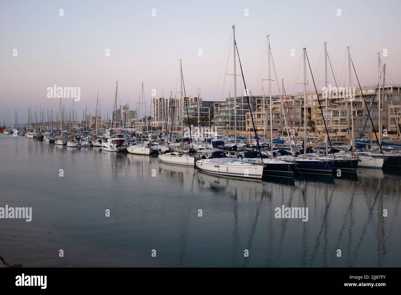 Yachts and sailing boats are seen at a seaside port Stock Photo - Alamy