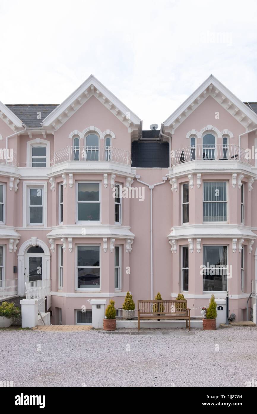 A vertical shot of pink buildings in a Victorian style Stock Photo - Alamy