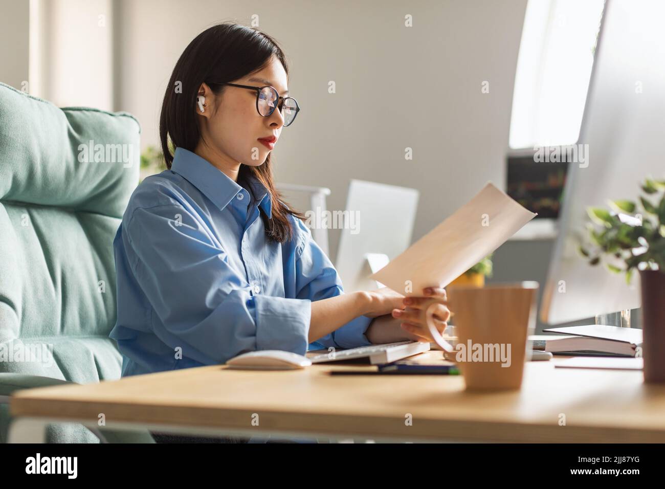 Korean Millennial Businesswoman Working With Papers Using Computer In ...